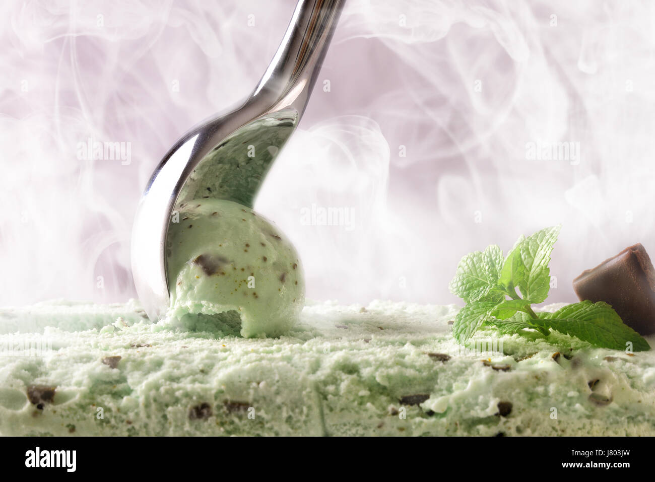 Making a mint choco ice cream. Front view of ice cream container and ...
