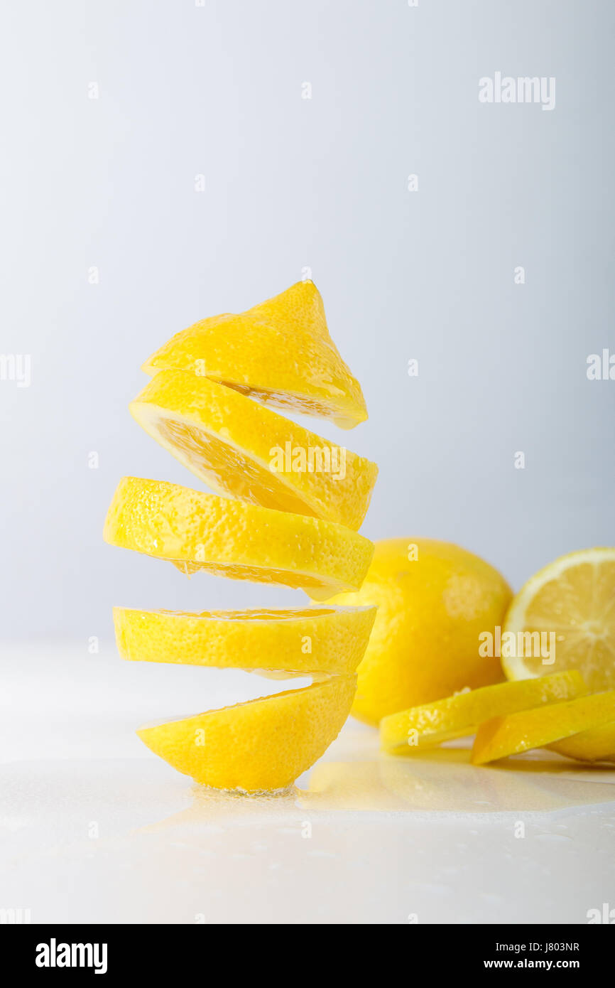 Flying lemon. Sliced lemon on white background. Levity fruit floating ...