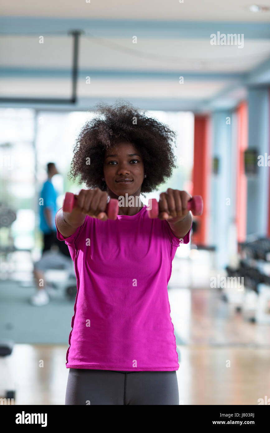 happy healthy african american woman working out in a crossfit gym on ...