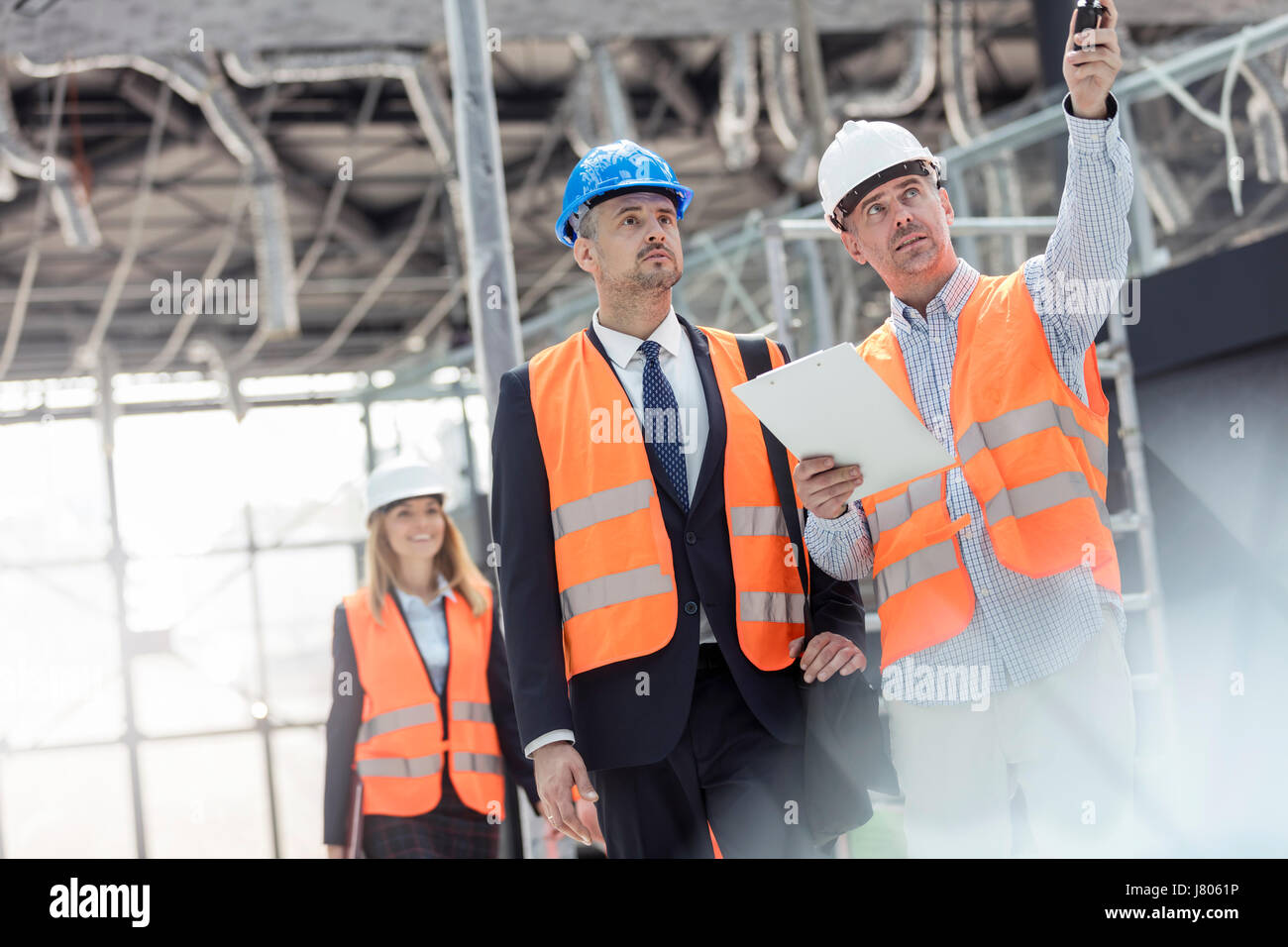 Businessman and engineer talking at construction site Stock Photo - Alamy