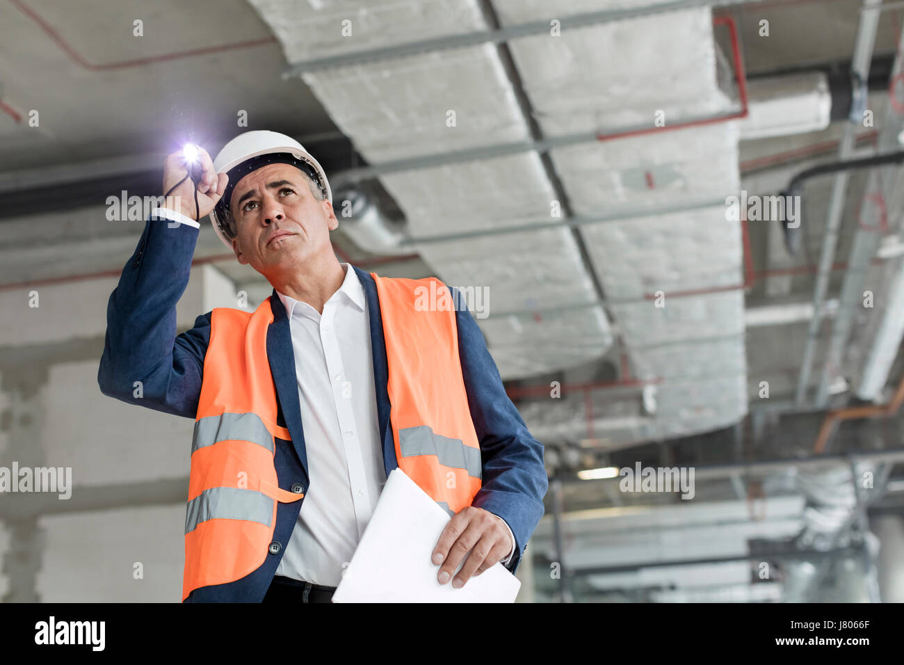 Foreman with flashlight at construction worker Stock Photo - Alamy