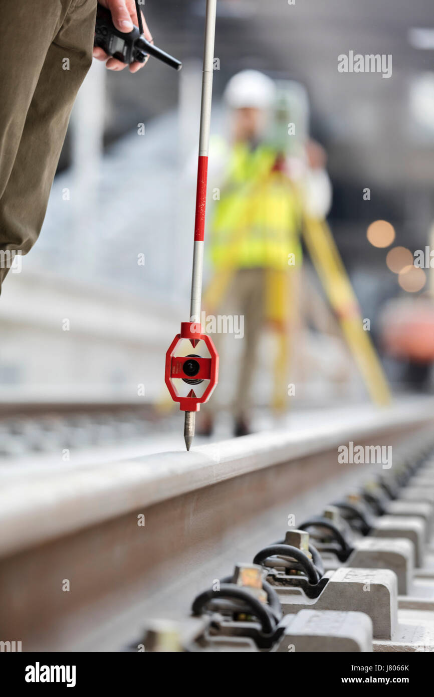 Engineers surveying tracks at construction site Stock Photo - Alamy