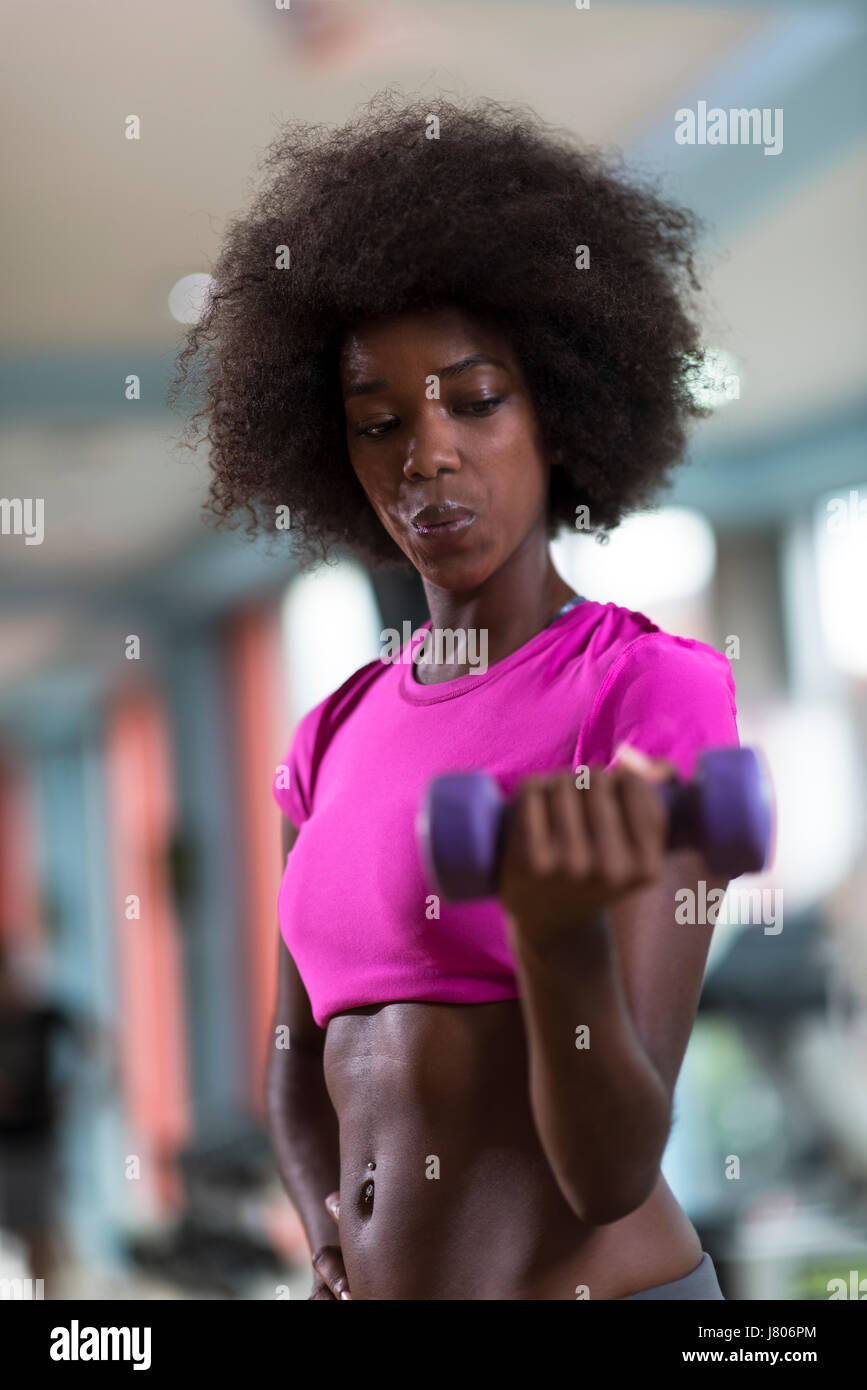 happy healthy african american woman working out in a crossfit gym on ...