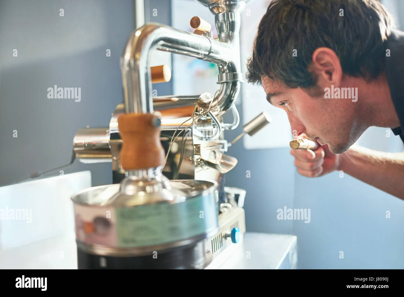 Male coffee roaster smelling, testing coffee Stock Photo - Alamy