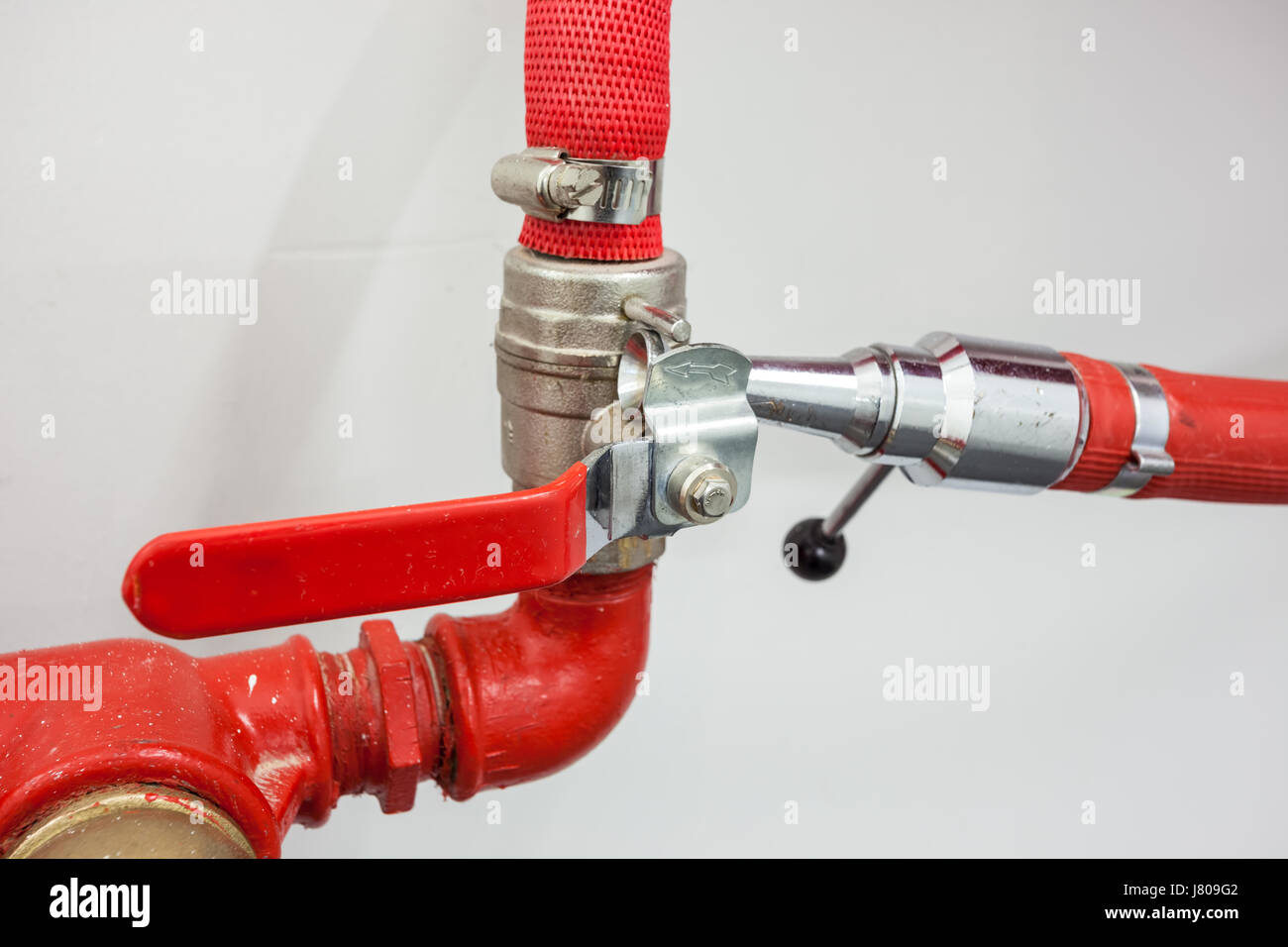 in the hallway of a nice building, there is a fire hose Stock Photo - Alamy