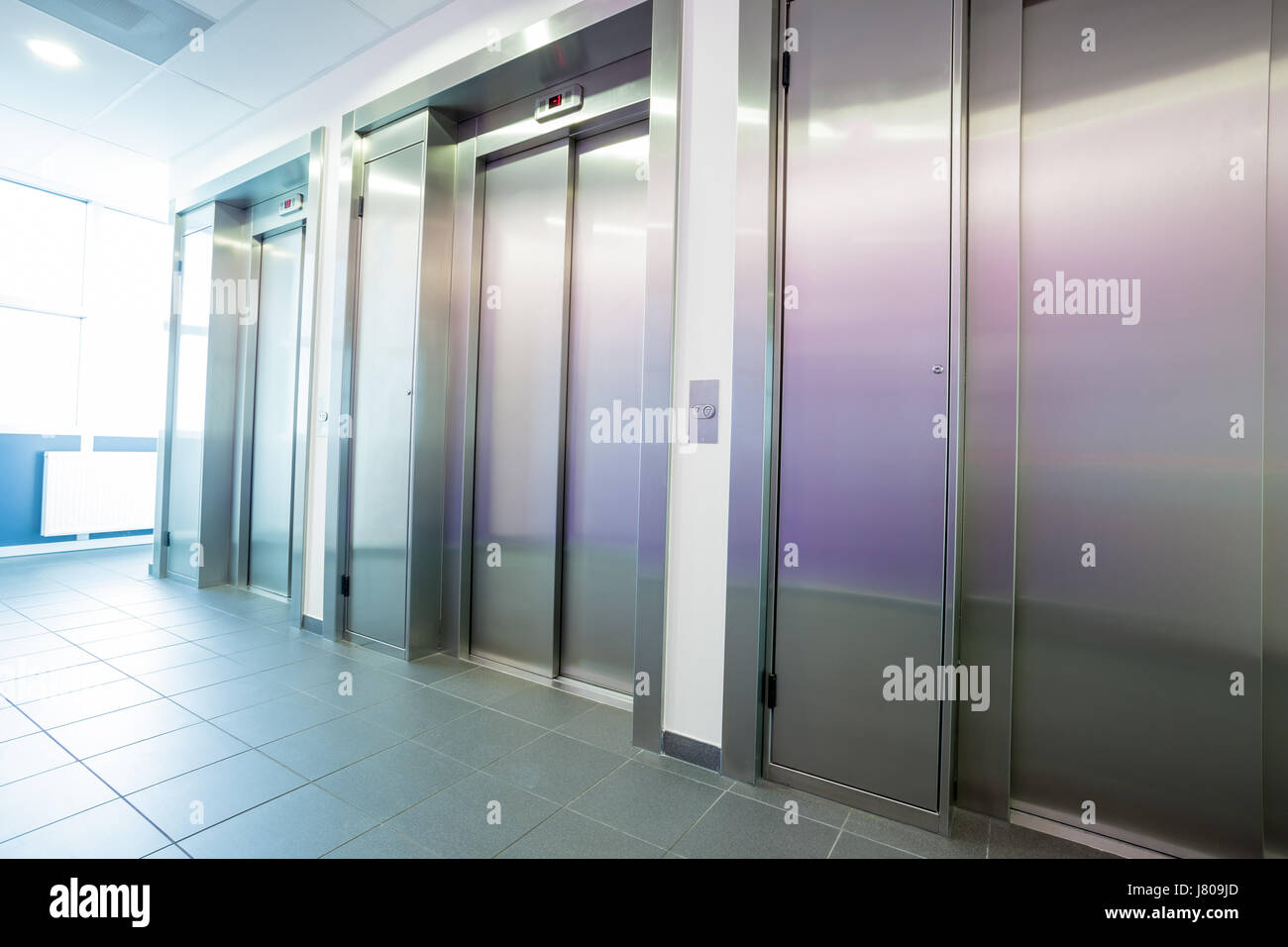 closed elevator on the third floor of an long corridor Stock Photo - Alamy