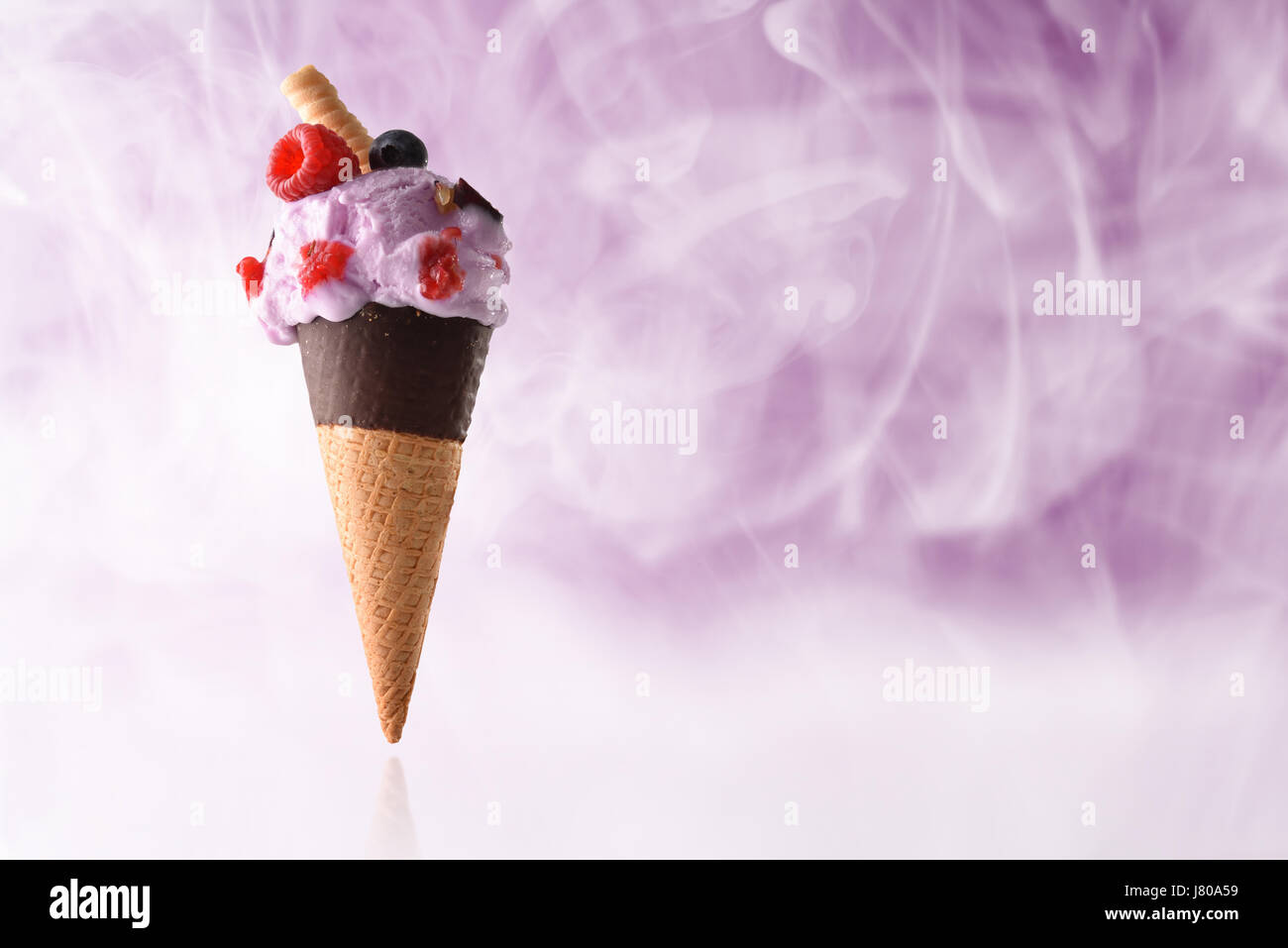 Ice cream cone flavored berries. Elevated on reflective table and ...