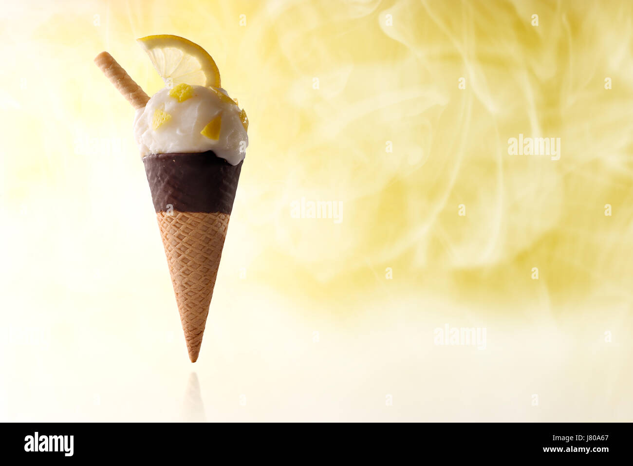 Ice cream cone flavored lemon. Elevated on reflective table and ...