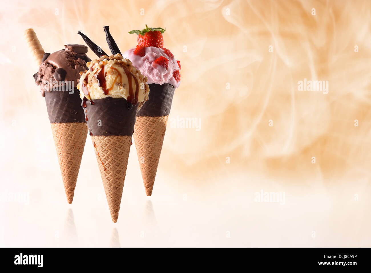 Strawberry, vanilla and chocolate cone ice cream with steam background ...