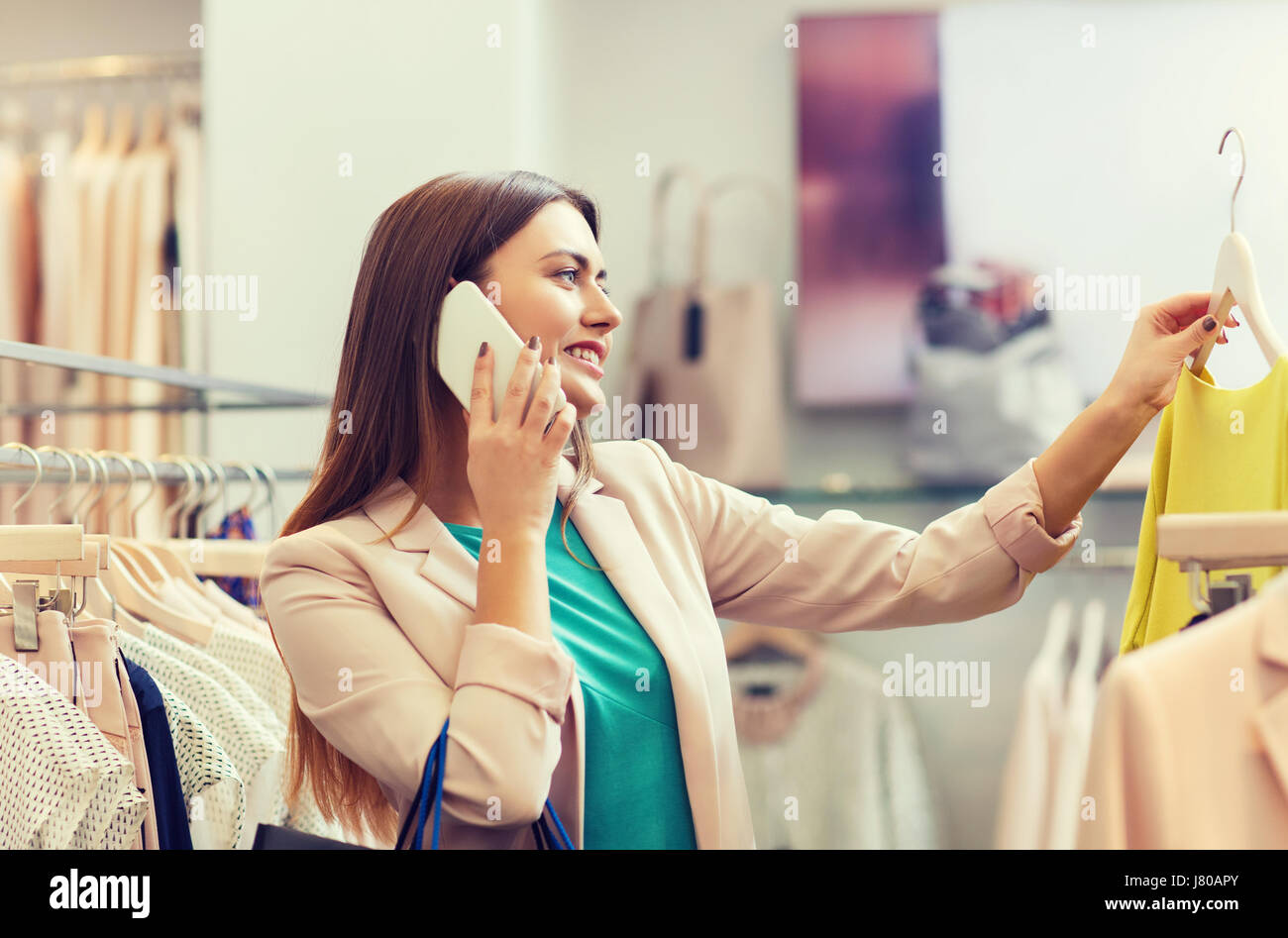 woman calling on smartphone at clothing store Stock Photo - Alamy