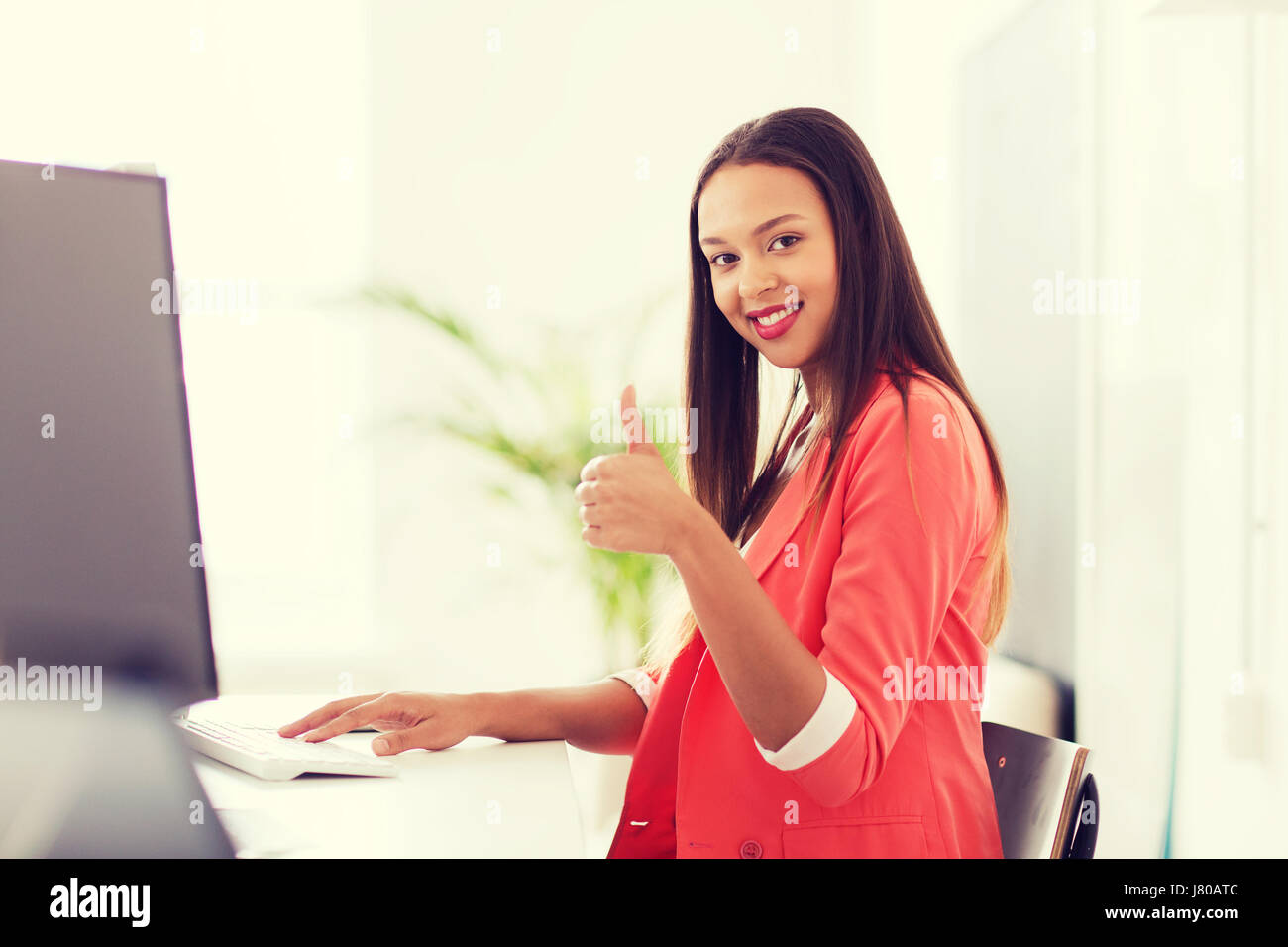 happy african woman with computer at office Stock Photo - Alamy