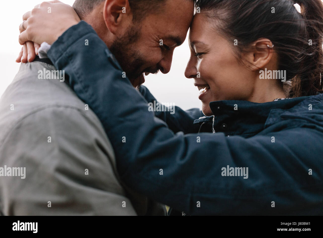 Close-up side portrait of a young couple in love to looking each other ...