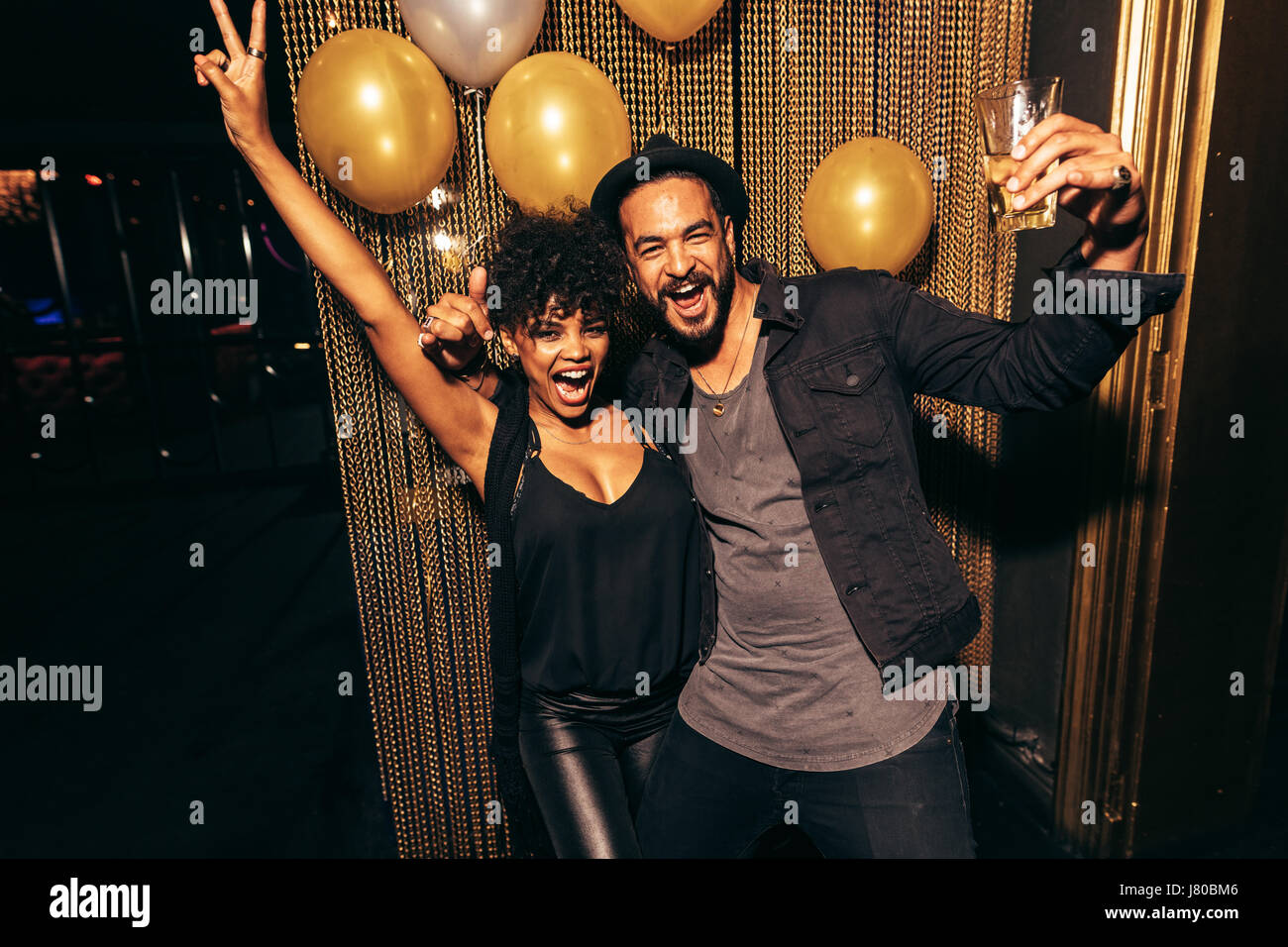 Couple smiling and dancing, having fun during disco party. Happy man ...