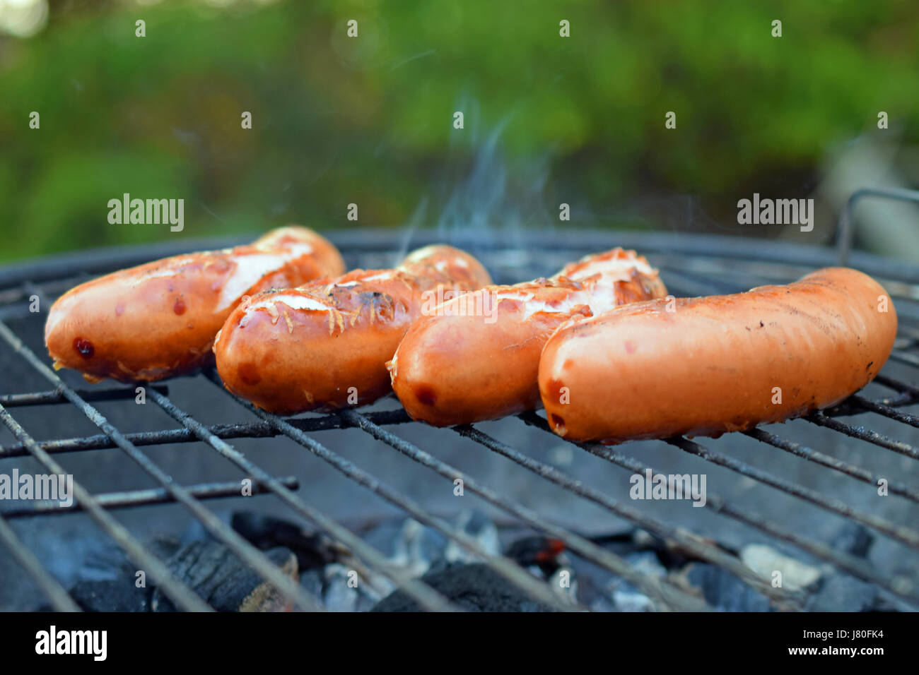 Barbecue. Sausages on grill Stock Photo - Alamy