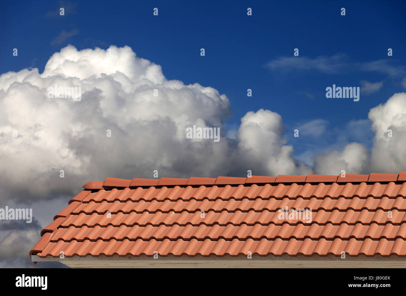 Roof tiles and blue sky with clouds Stock Photo - Alamy