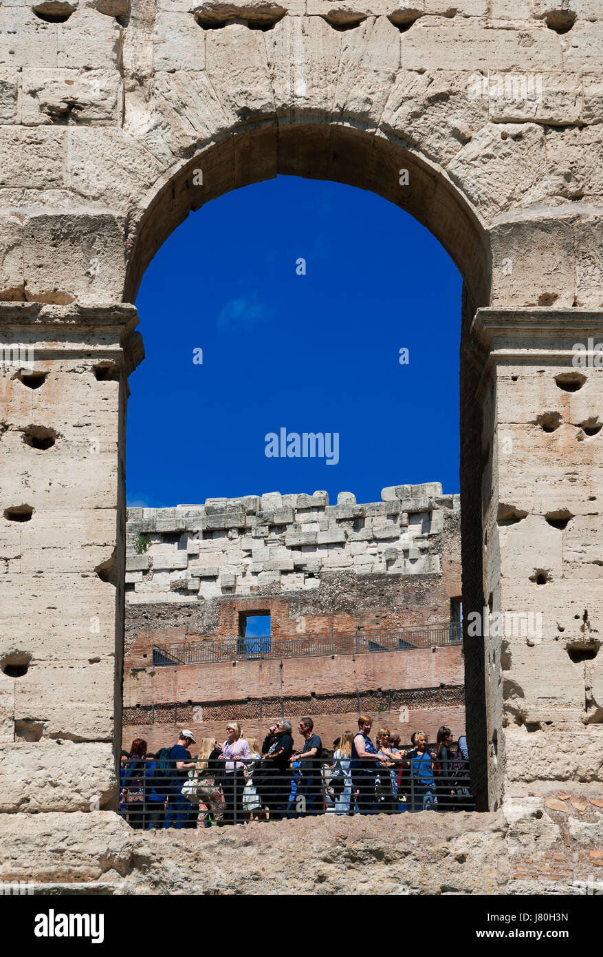 Tourists visiting Coliseum monumental arcades in Rome Stock Photo - Alamy