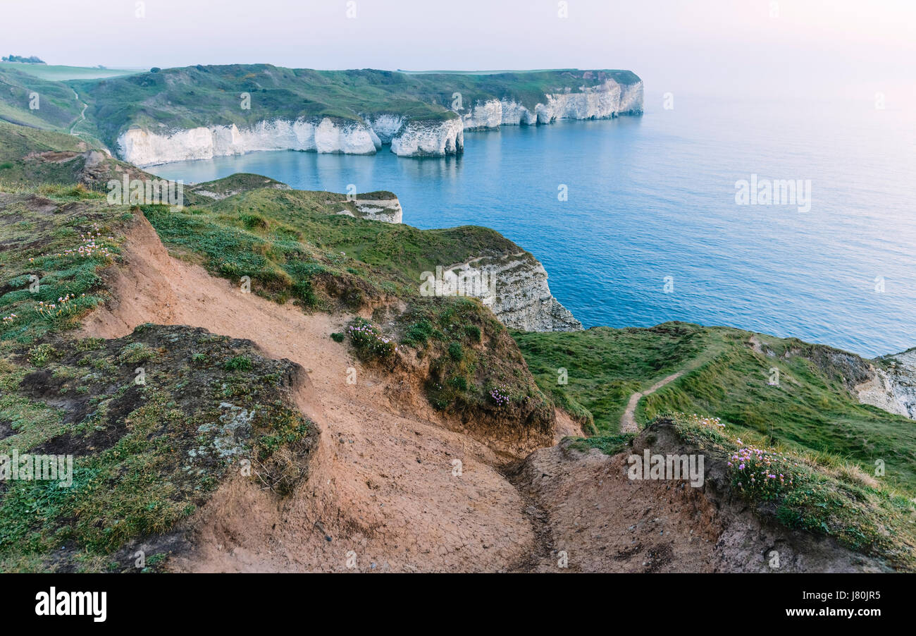 Sea and weather erosion along the high chalk cliffs on a fine sunrise ...
