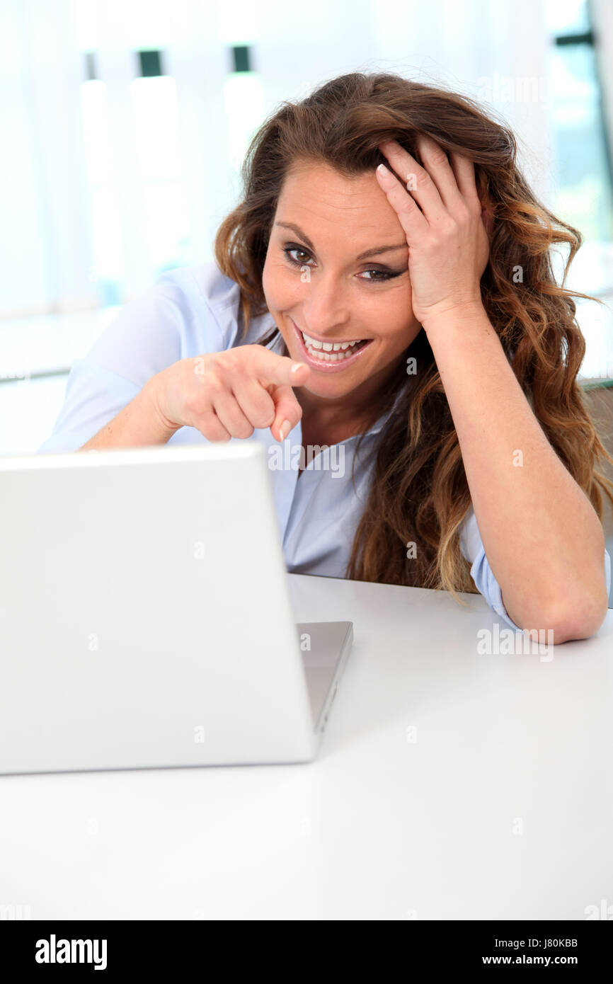 woman office laptop notebook computers computer laugh laughs laughing ...