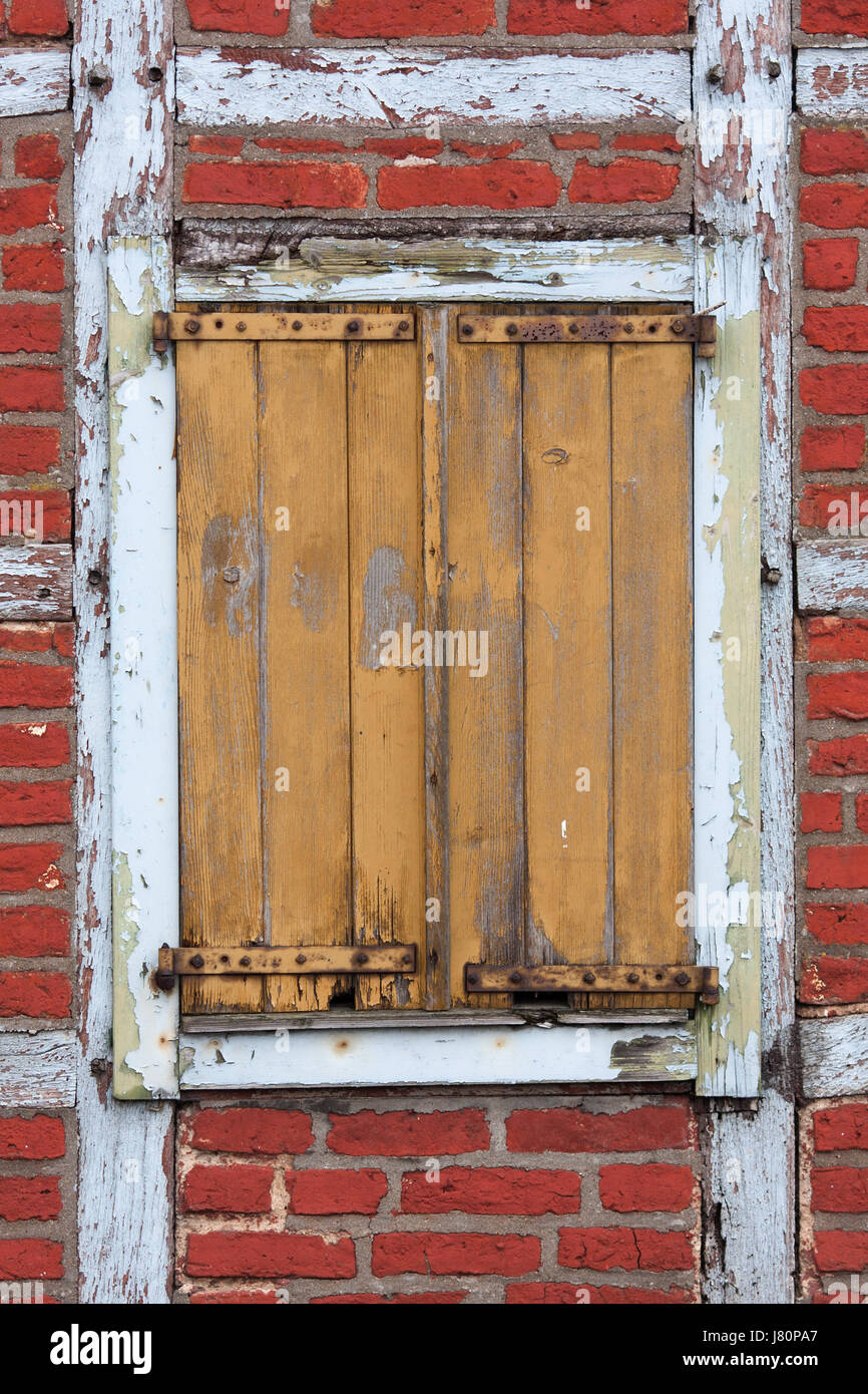 window porthole dormer window pane frame-work brick shutters brick wall ...