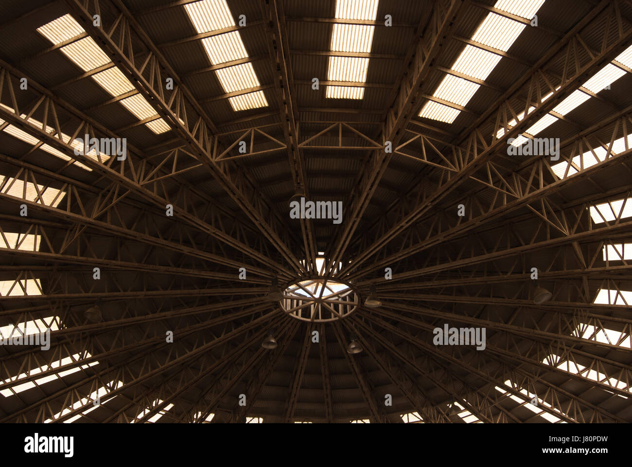 A metal roof structure over a sports arena. The steel girders making ...