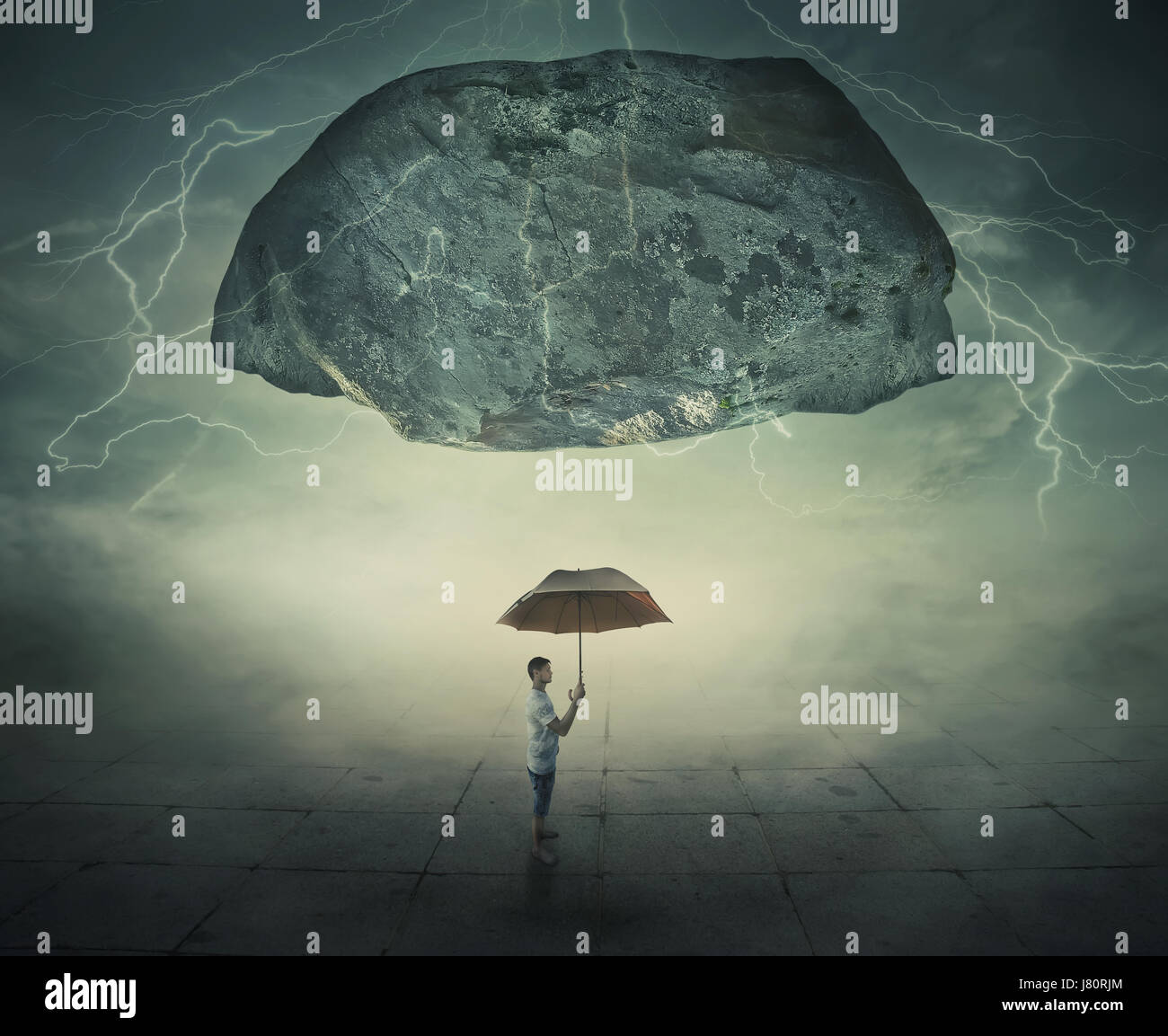 Surrealistic image as a man stand in a foggy street under a huge ...