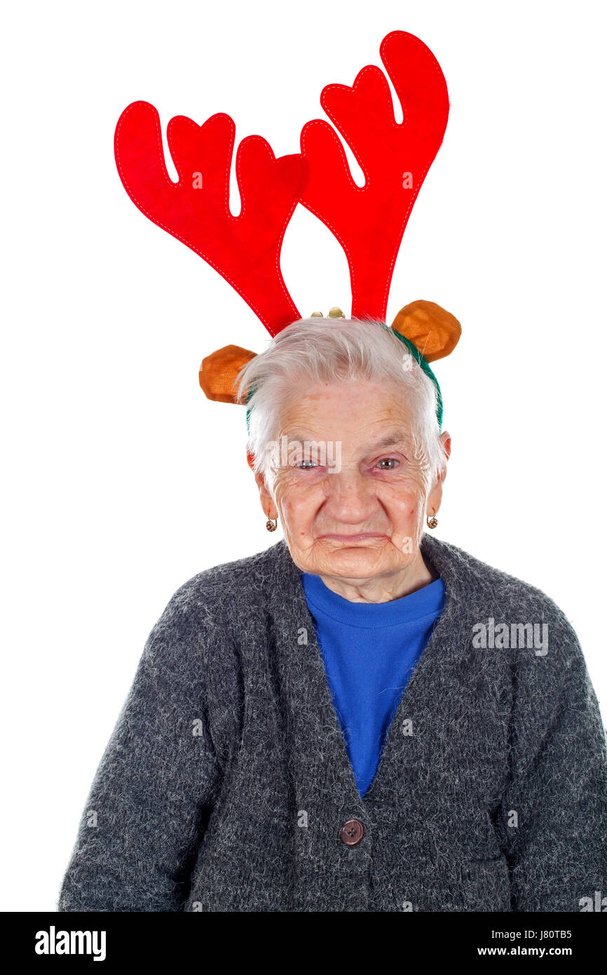 Portrait of an old woman wearing a reindeer slide on an isolated ...