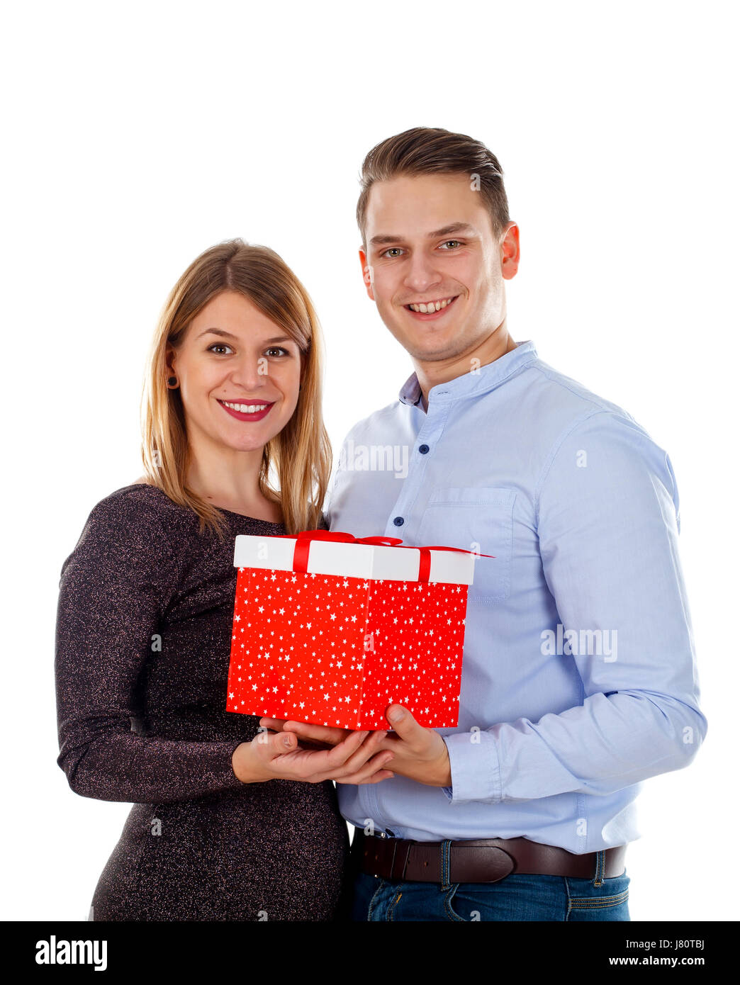 Picture of an attentive man giving a surprise-gift to his girlfriend ...