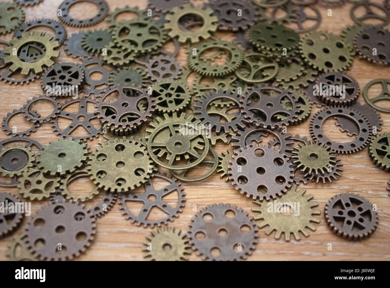 Metal cogs on wood Stock Photo - Alamy