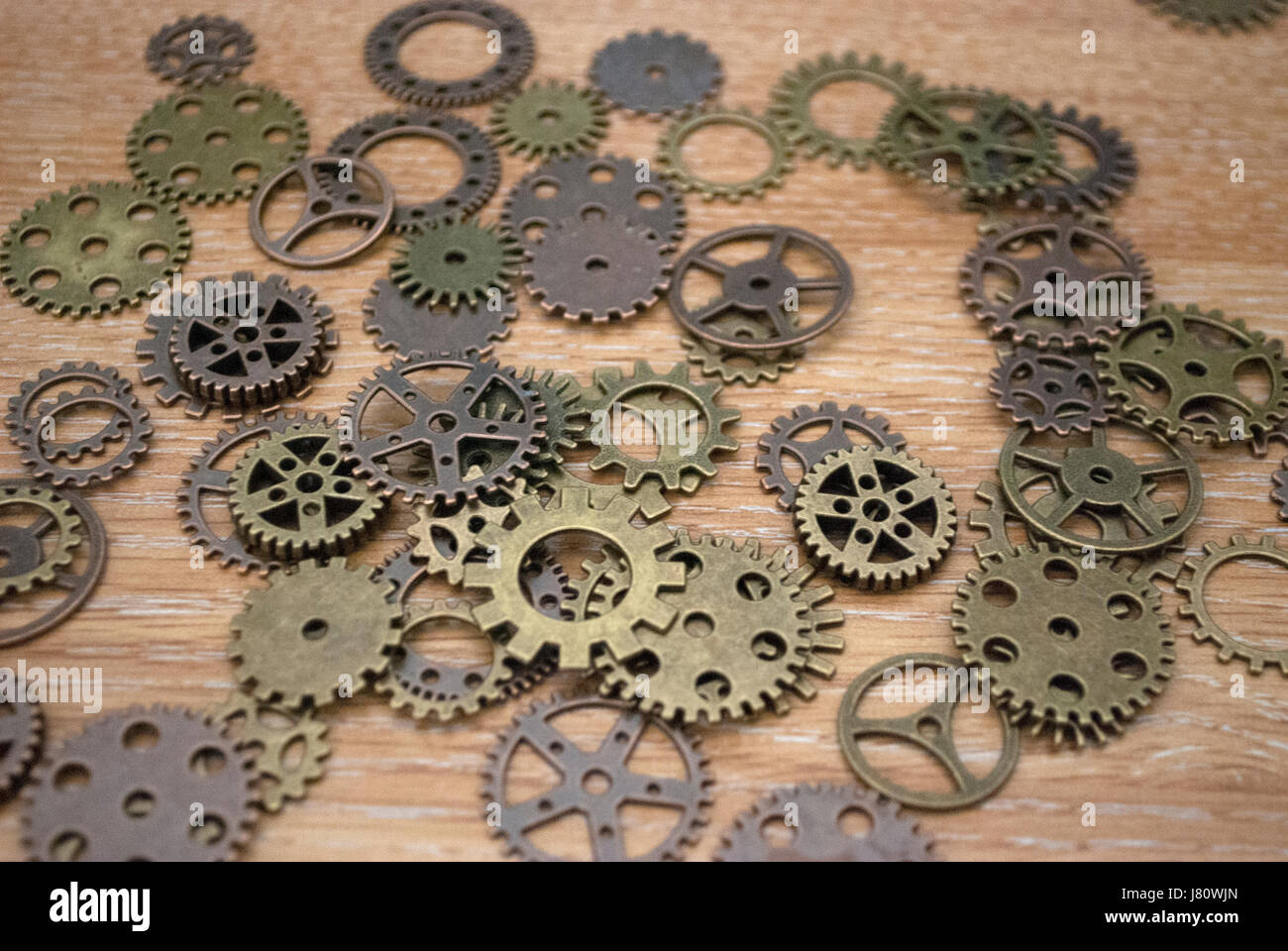 Metal cogs on wood Stock Photo - Alamy