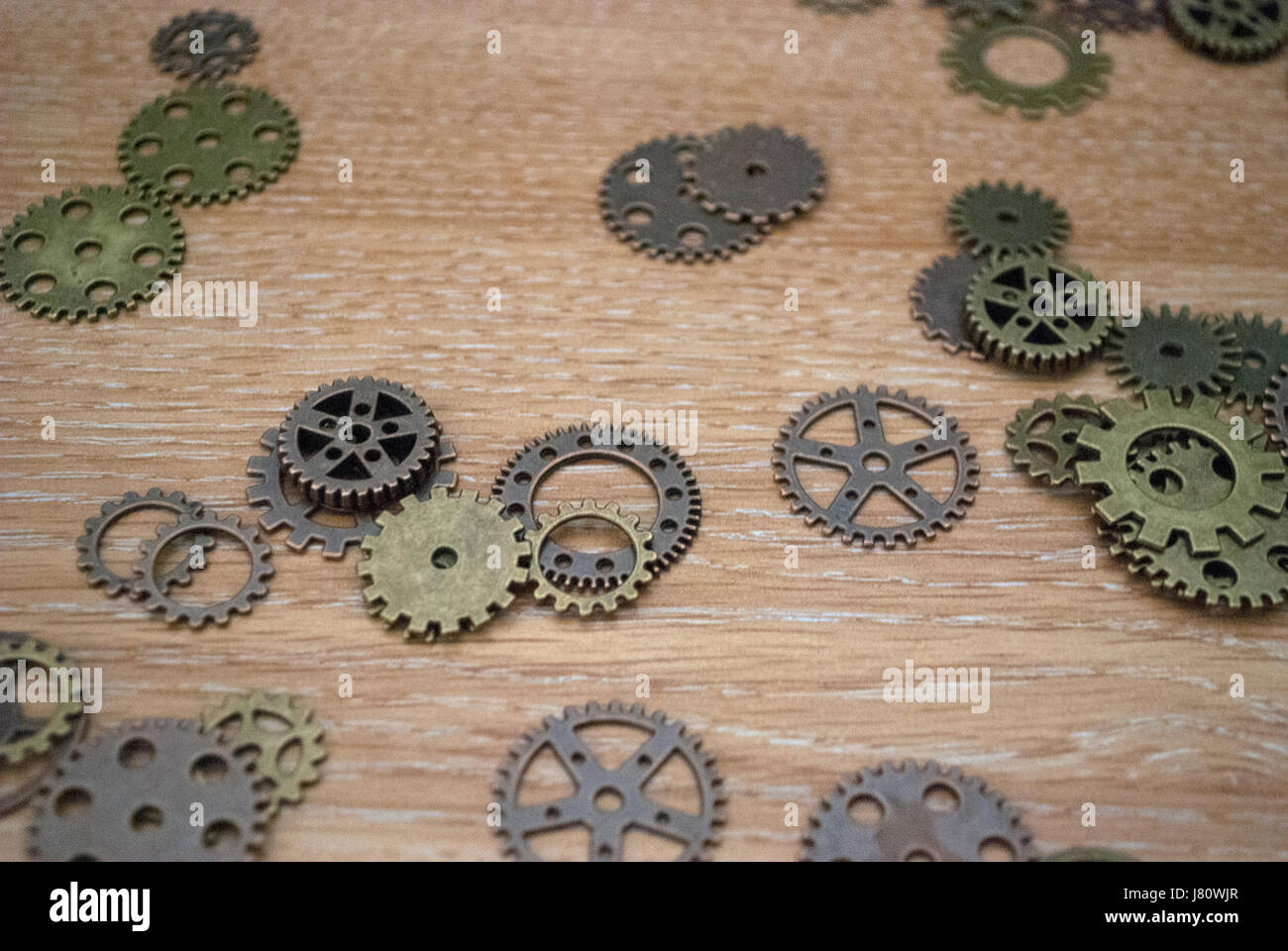 Metal cogs on wood Stock Photo - Alamy