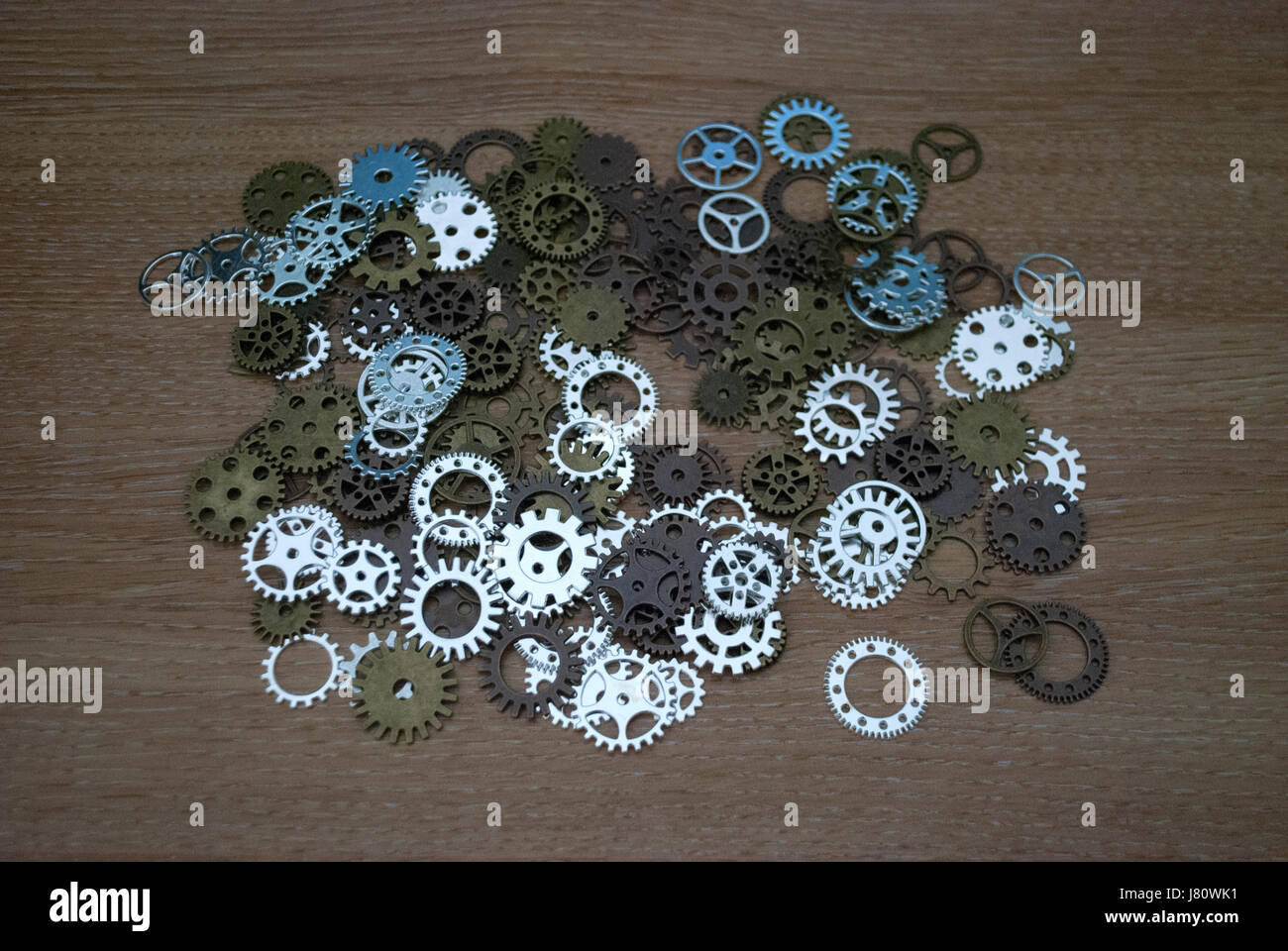 Metal cogs on wood Stock Photo - Alamy