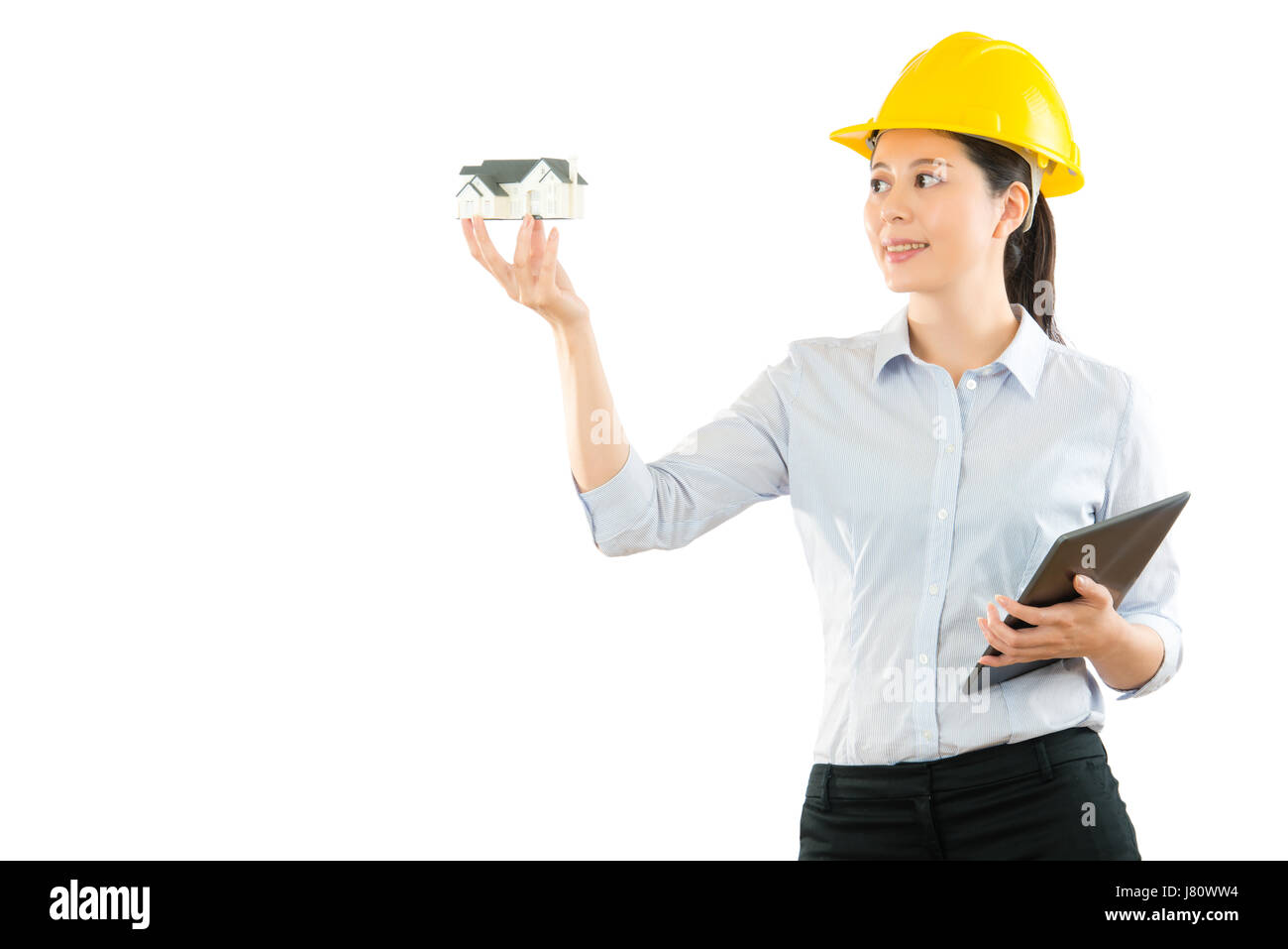 portrait of female building engineering designer showing house model ...
