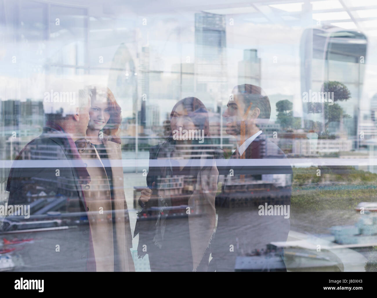 Business people talking at urban window with city view, London, UK ...