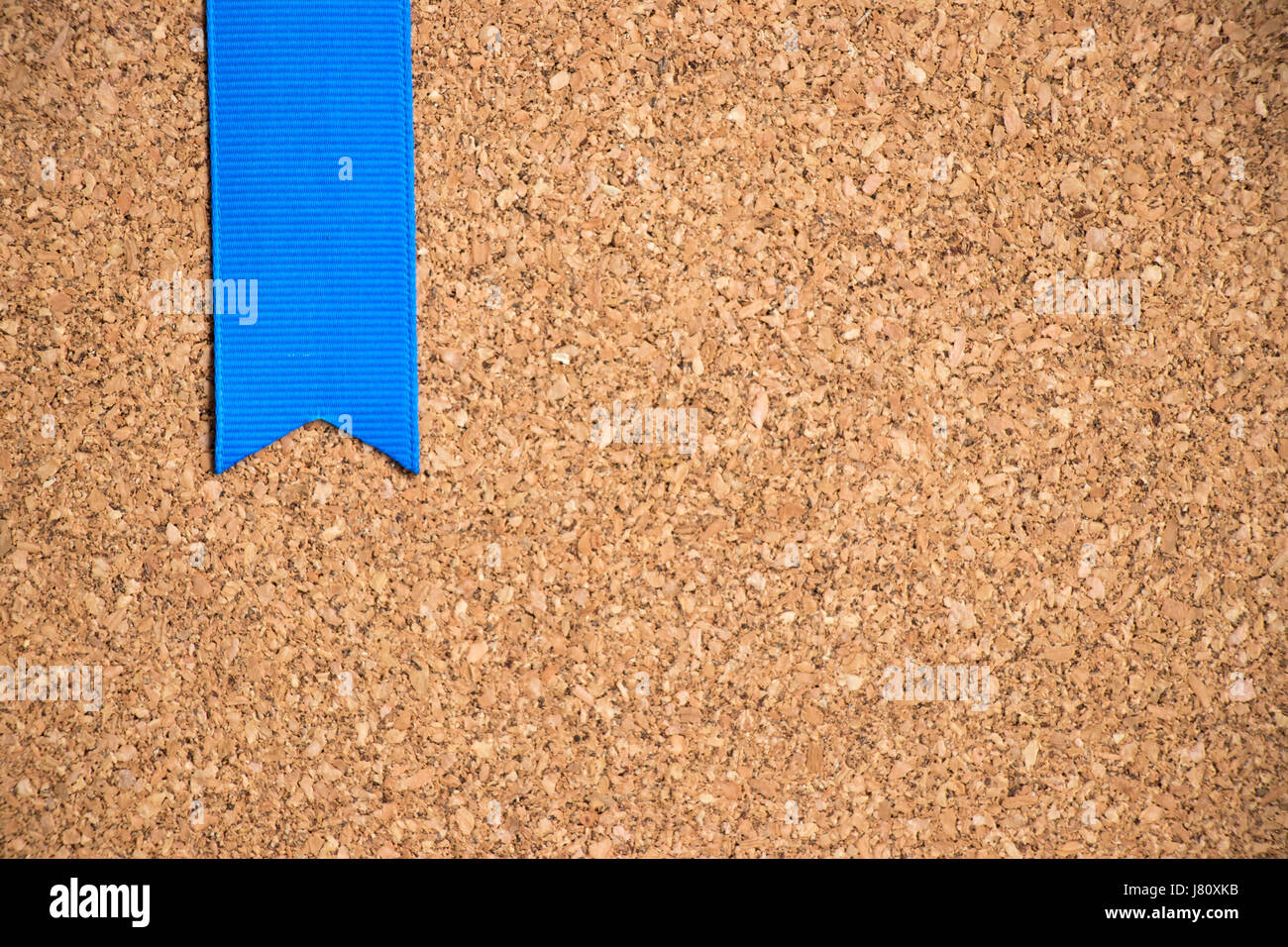 Blue ribbon on cork board texture background Stock Photo - Alamy