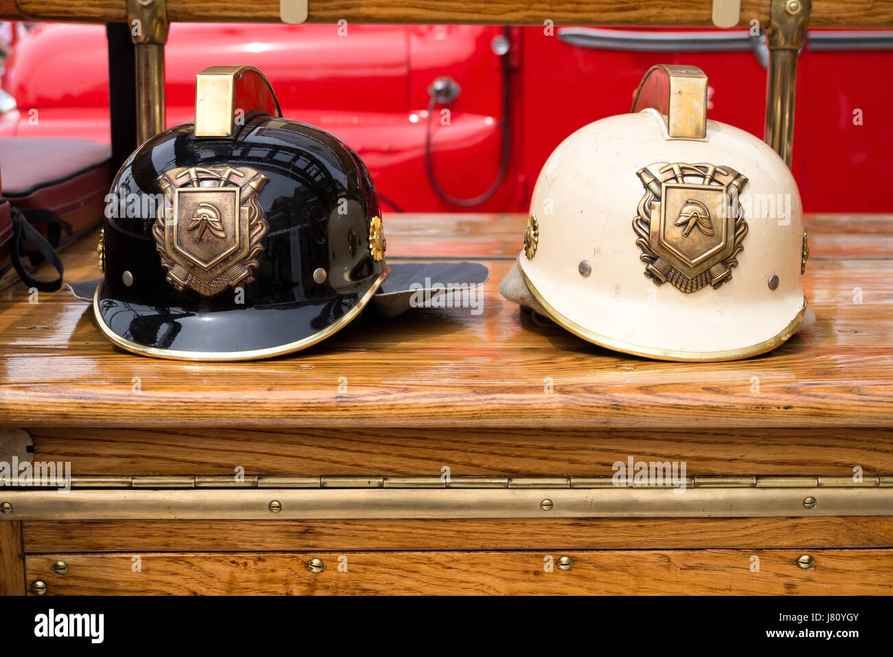 two old firefighter's helmets on board a classic fire engine Stock ...