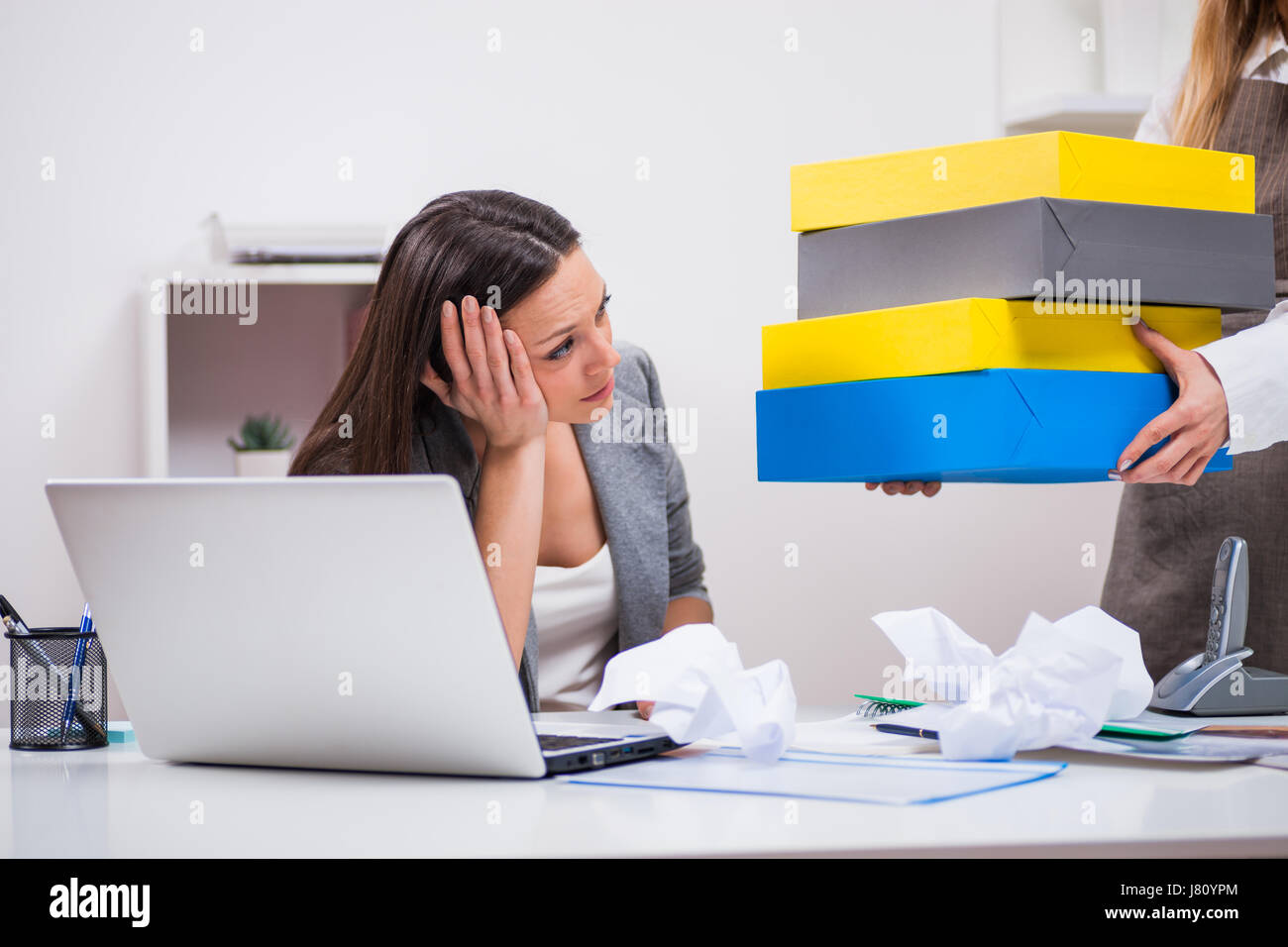 Young businesswoman is sad because she has too much work Stock Photo ...