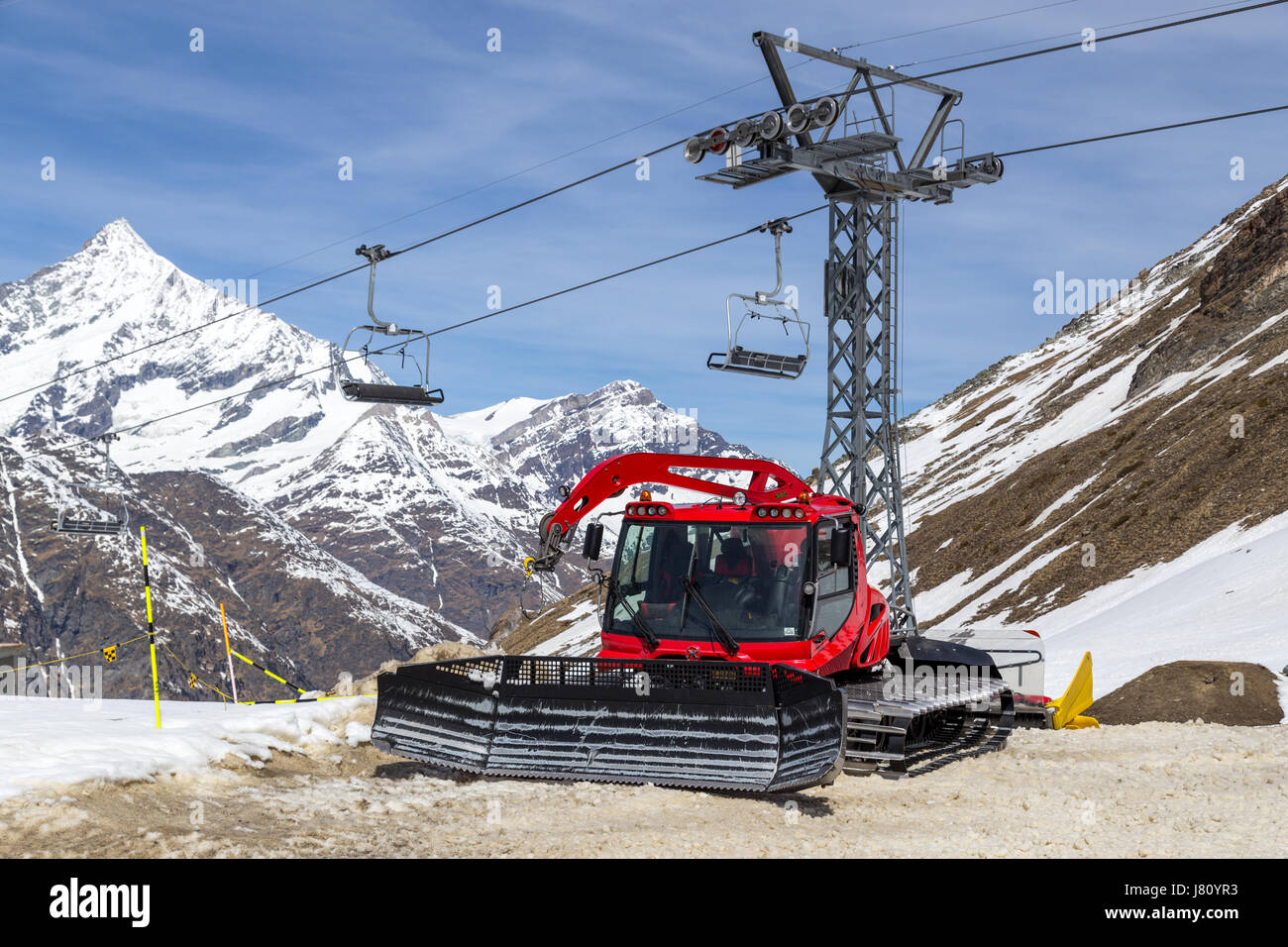 Zermatt, Switzerland - April 12, 2017: A red snow grooming machine ...