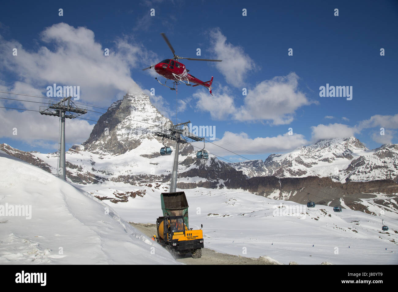 Zermatt, Switzerland - April 13, 2017: A helicopter loading concrete at ...