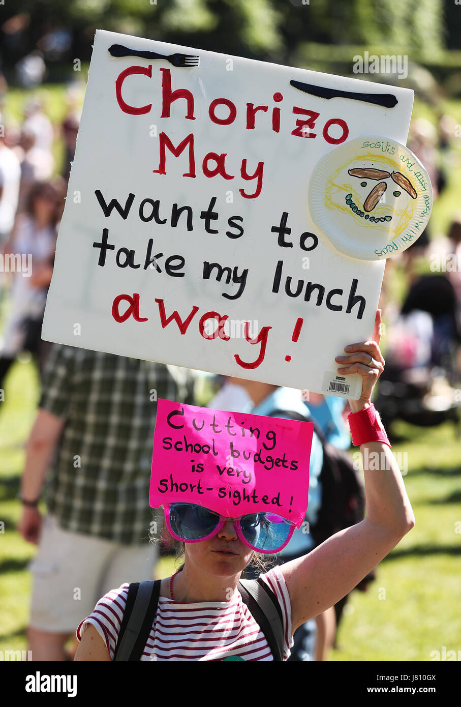 A teacher holds a banner during a Save our Schools rally, at the Level ...