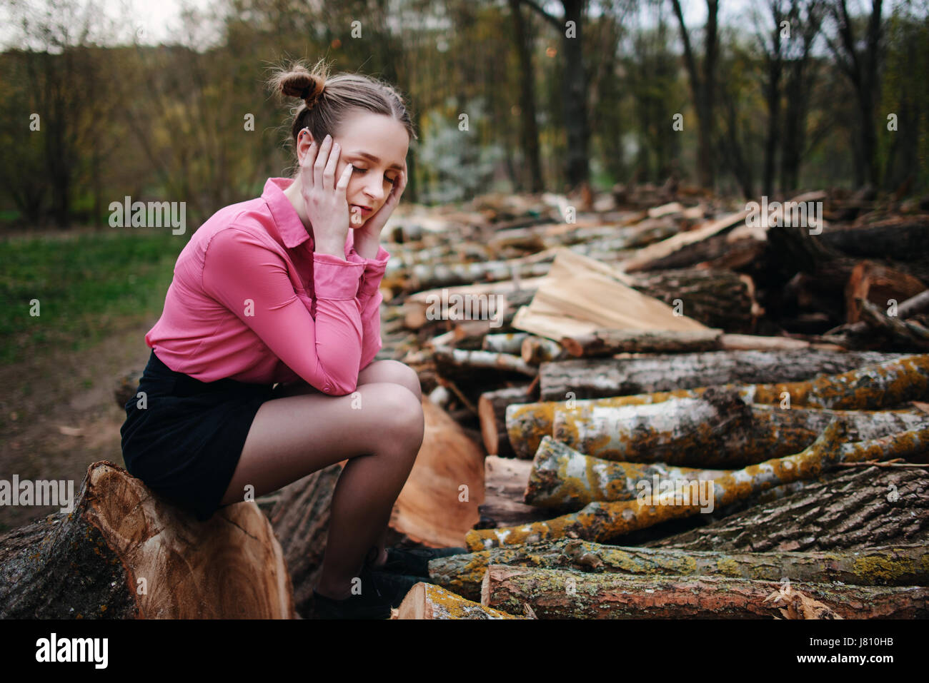 Woman sitting smiling on fallen tree hi-res stock photography and ...