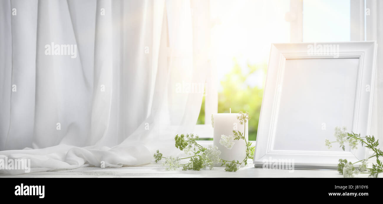 Picture frame near window with candle in the morning Stock Photo - Alamy