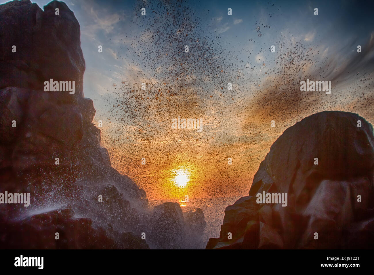 super bright storm at sunset provided sharp rocks of ocean. water ...