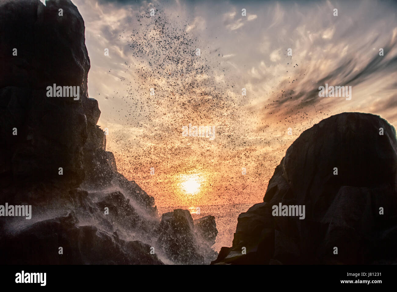 super bright storm at sunset provided sharp rocks of ocean. water ...