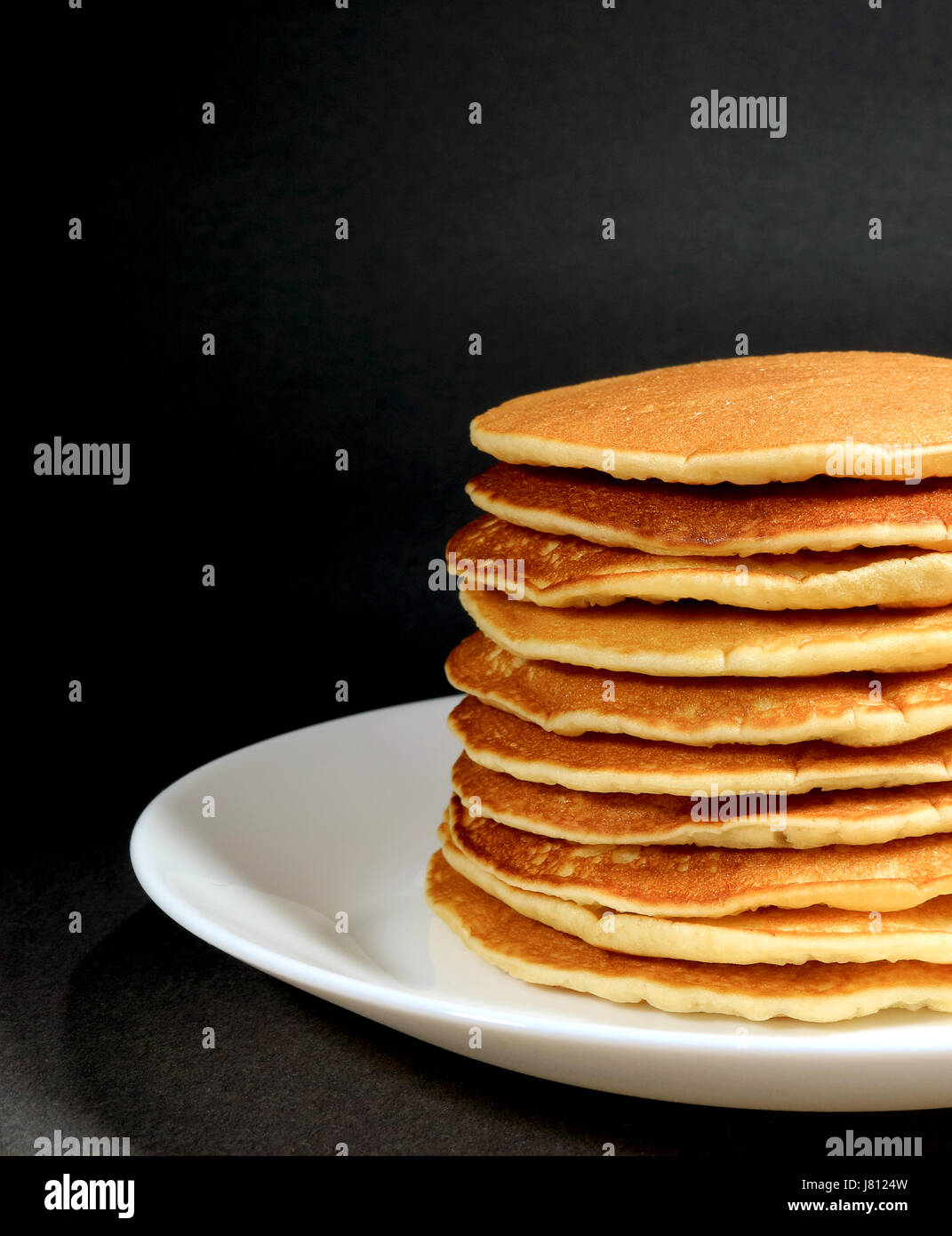 Vertical photo of fresh homemade plain pancakes stack served on white ...