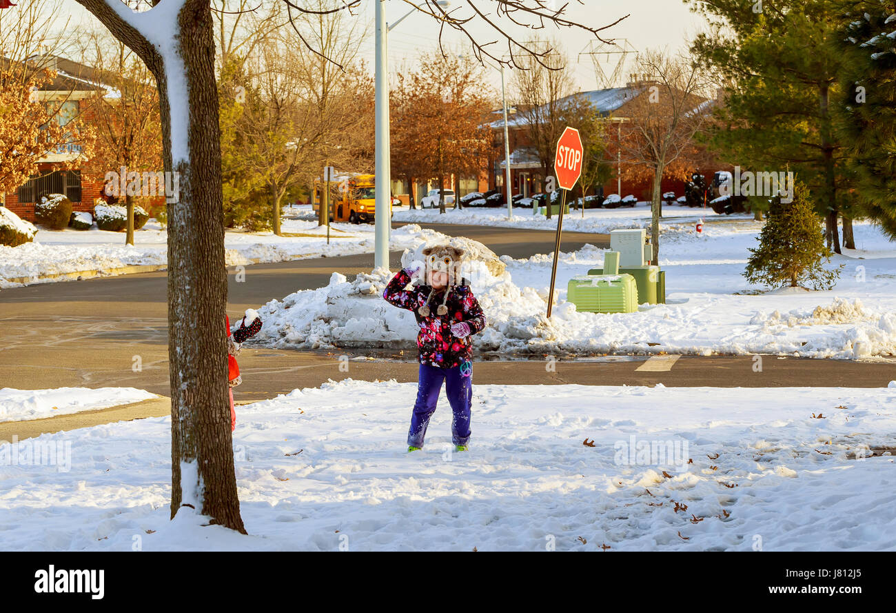 Winter snow little girl playing with snow Stock Photo - Alamy
