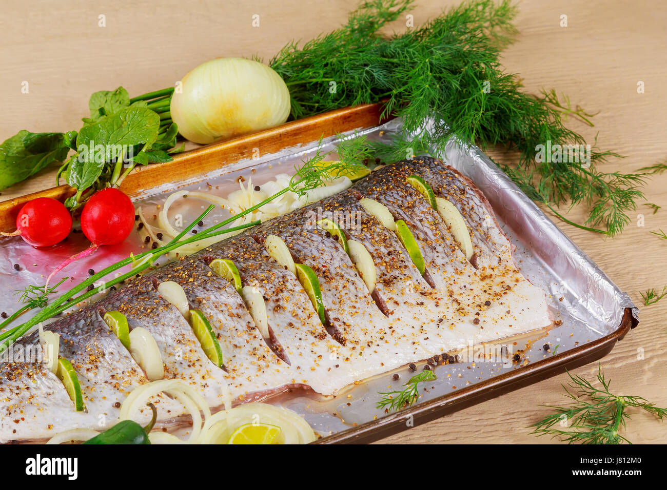 Delicious marinated fillet fish with lemon and onion dish in the oven ...