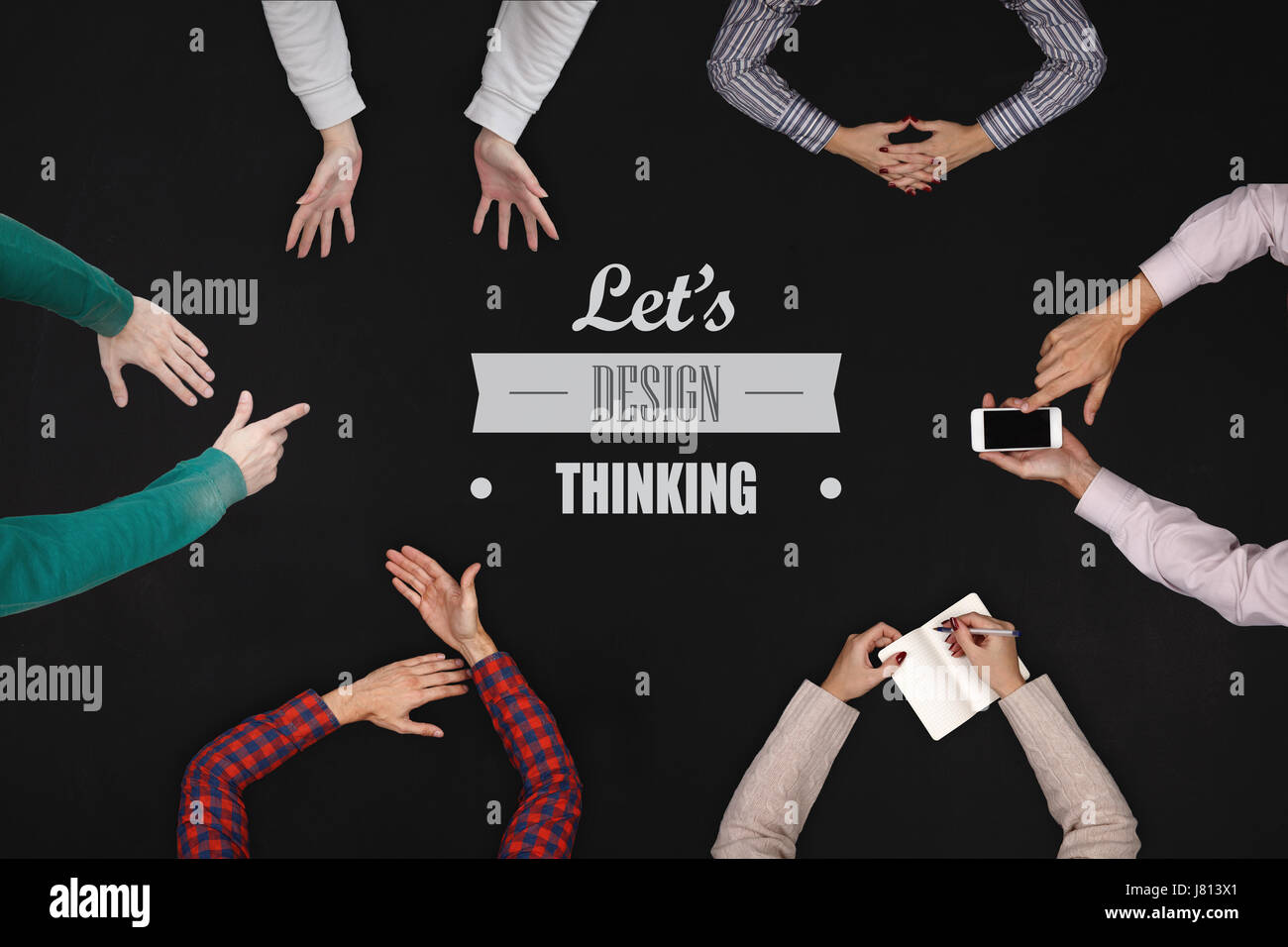 Teamwork concept - top view of six people work on a blackboard table ...