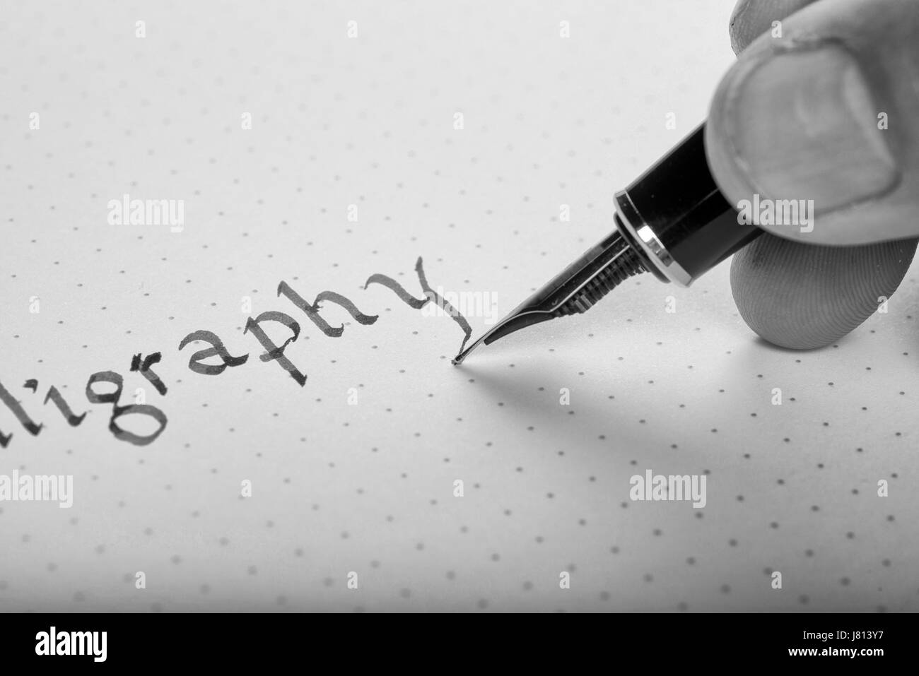 Hand holding a fountain pen to write on paper Stock Photo - Alamy