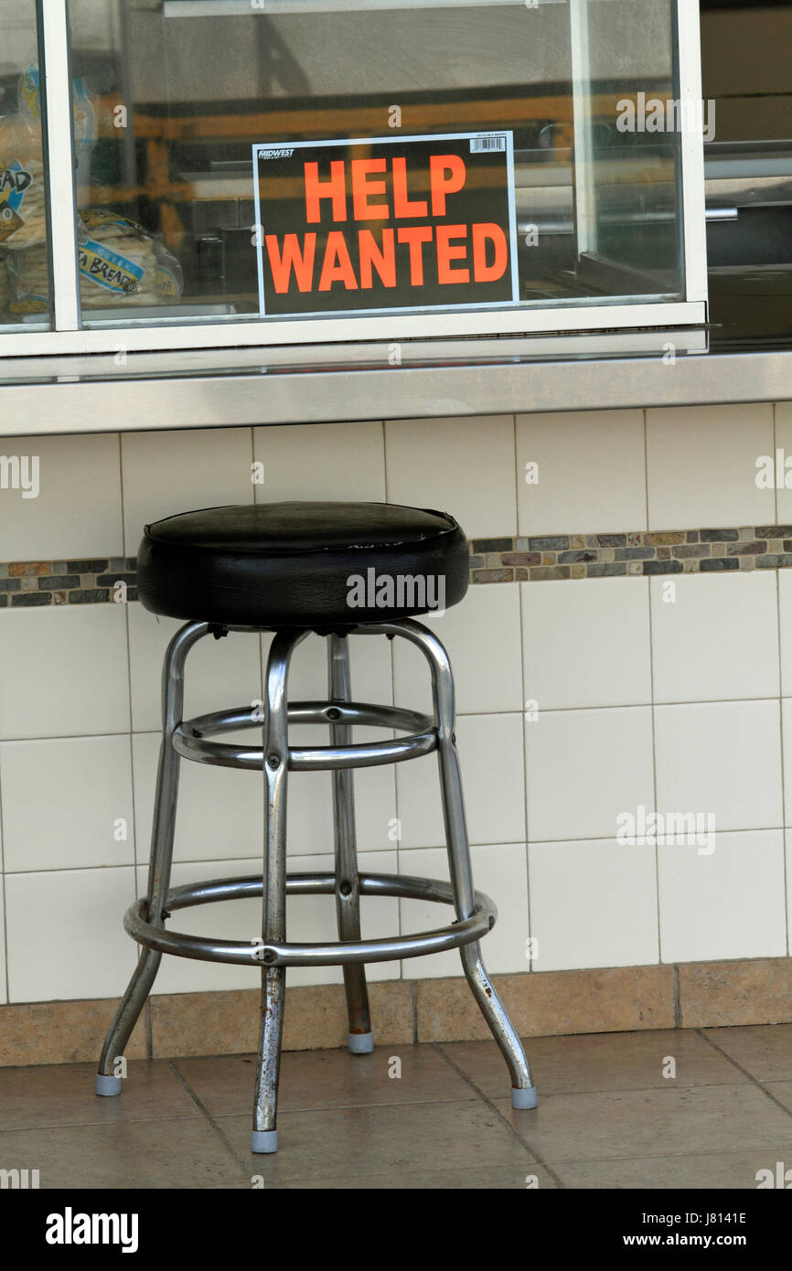 An empty chair at a help wanted sign Stock Photo - Alamy