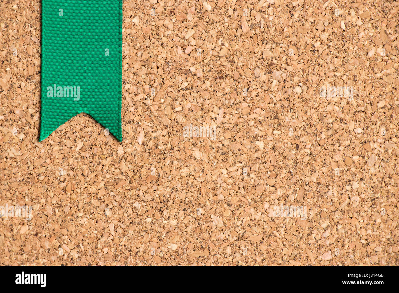 Green ribbon on cork board texture background Stock Photo - Alamy